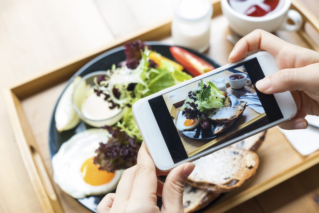 closeup hand holding phone shooting food photograph | Clearworks | Your ...